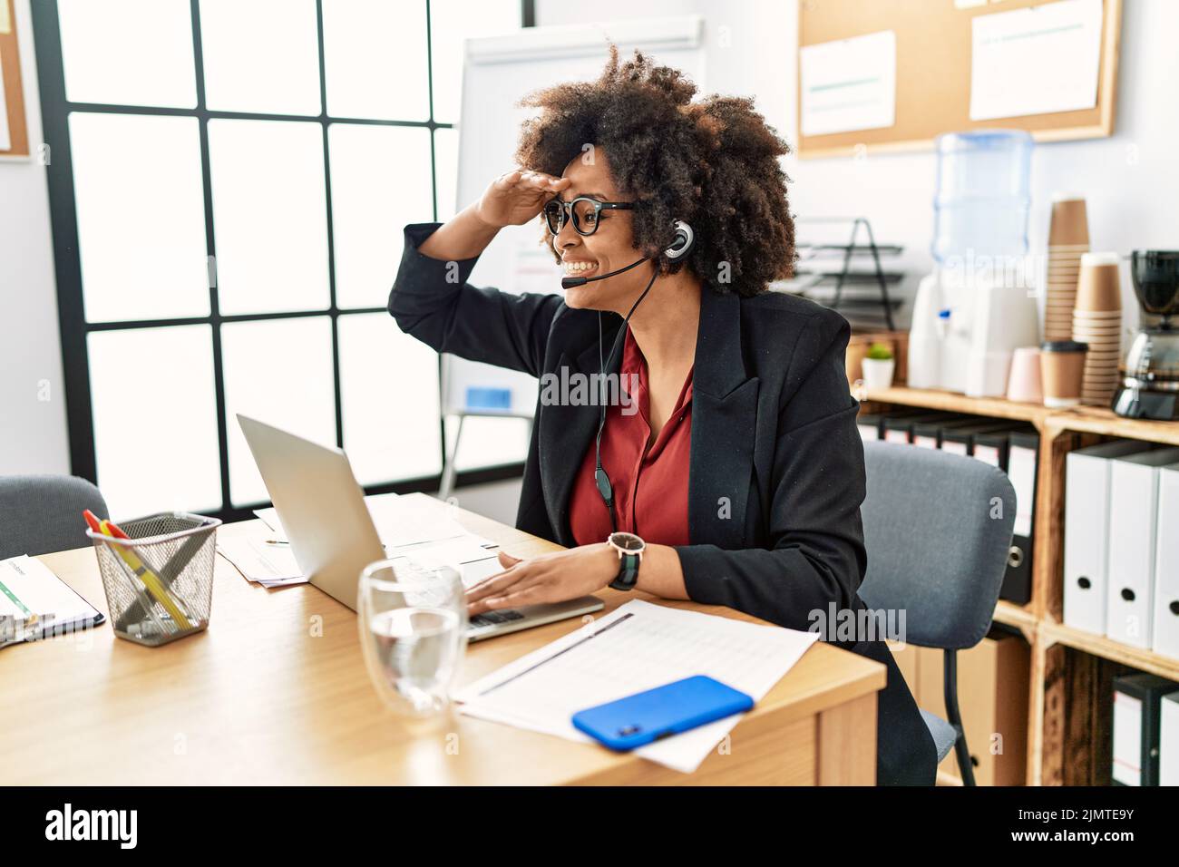 African american woman with afro hair working at the office wearing ...