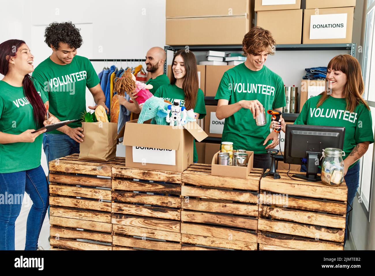 Group of young volunteers smiling happy working at charity center Stock ...