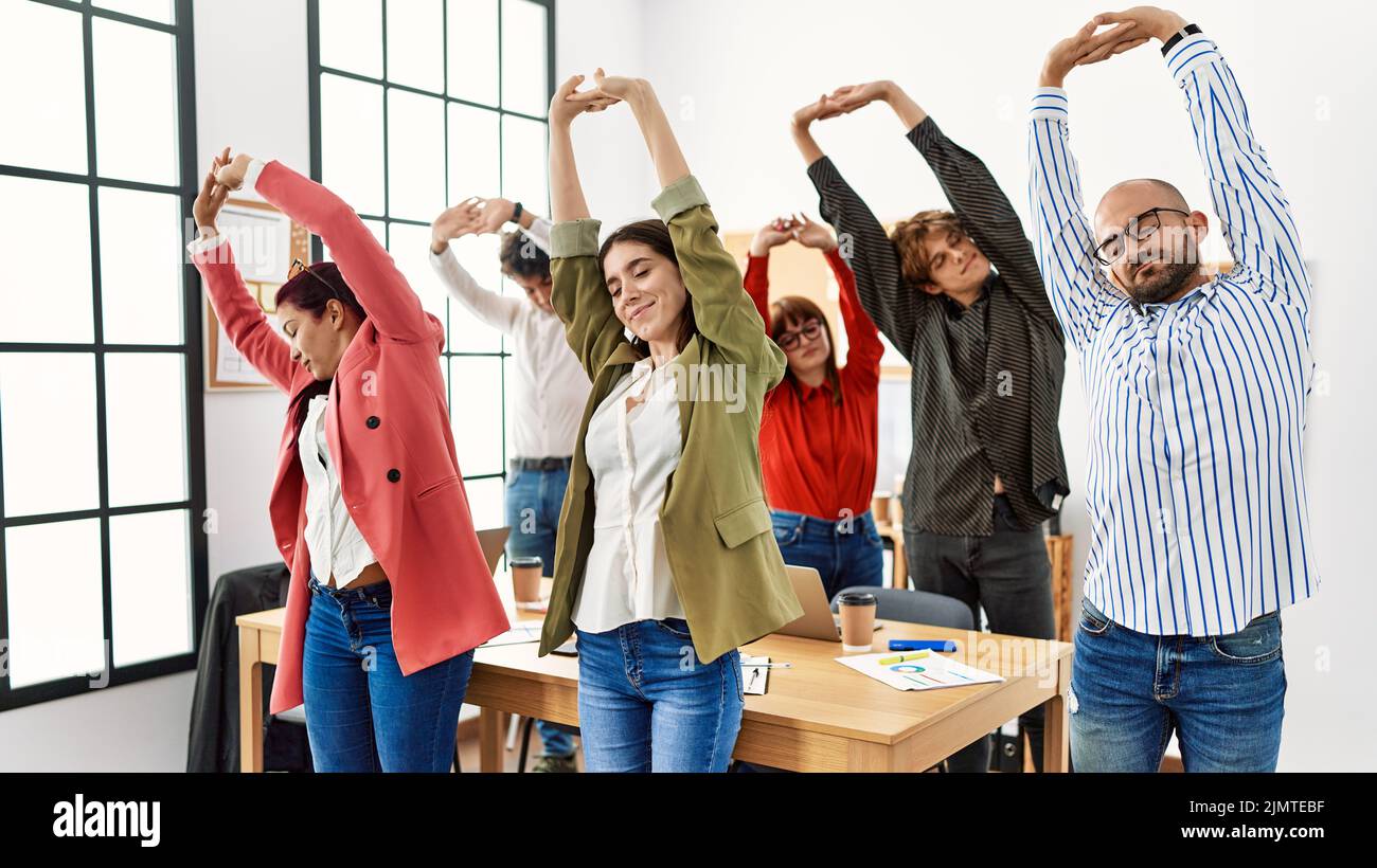Group of business workers stretching arms in relax time standing at the ...