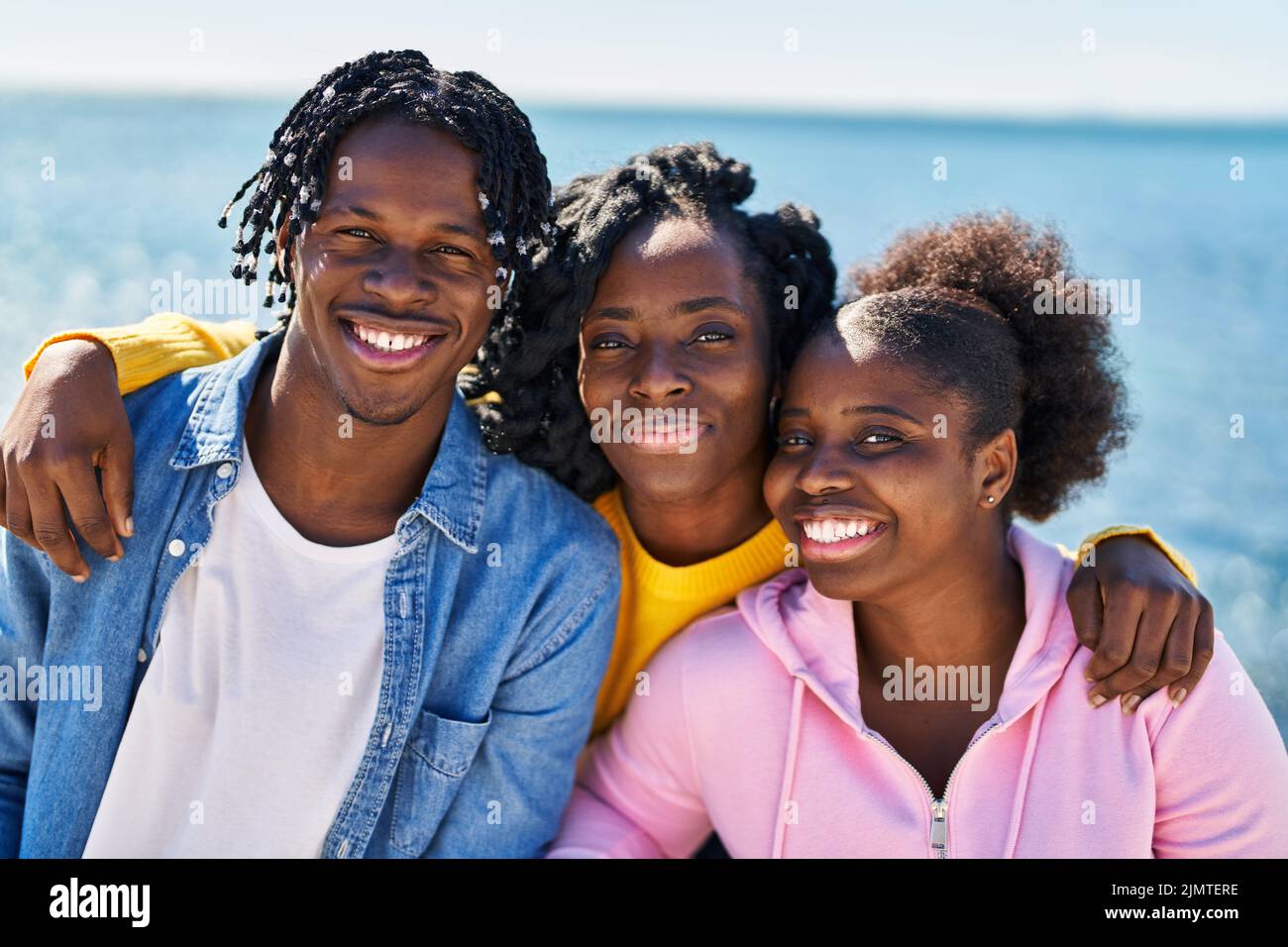 African american friends smiling confident hugging each other at ...