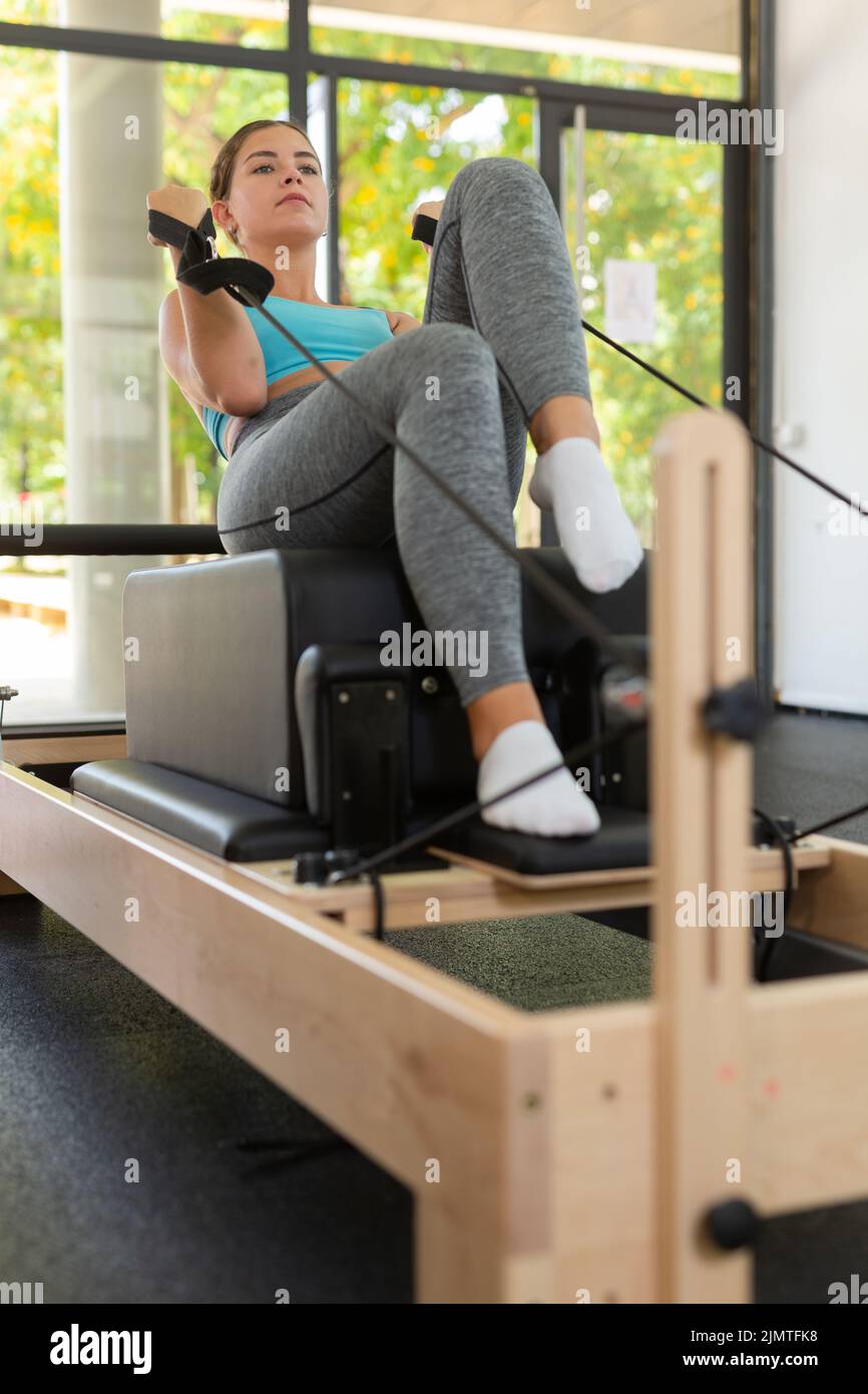 Girl pilates exercises on machines in a health club Stock Photo - Alamy
