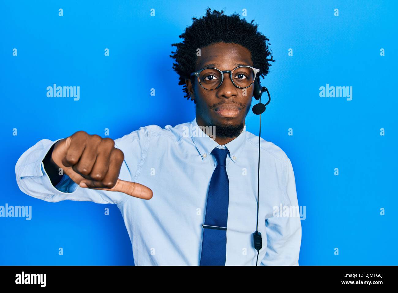 Young african american man wearing call center agent headset with angry ...