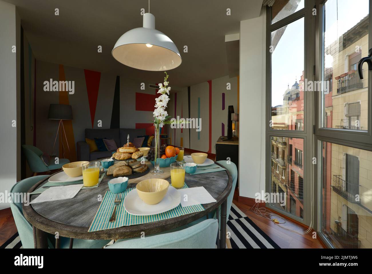 Living room with an industrial style dining table with green velvet ...