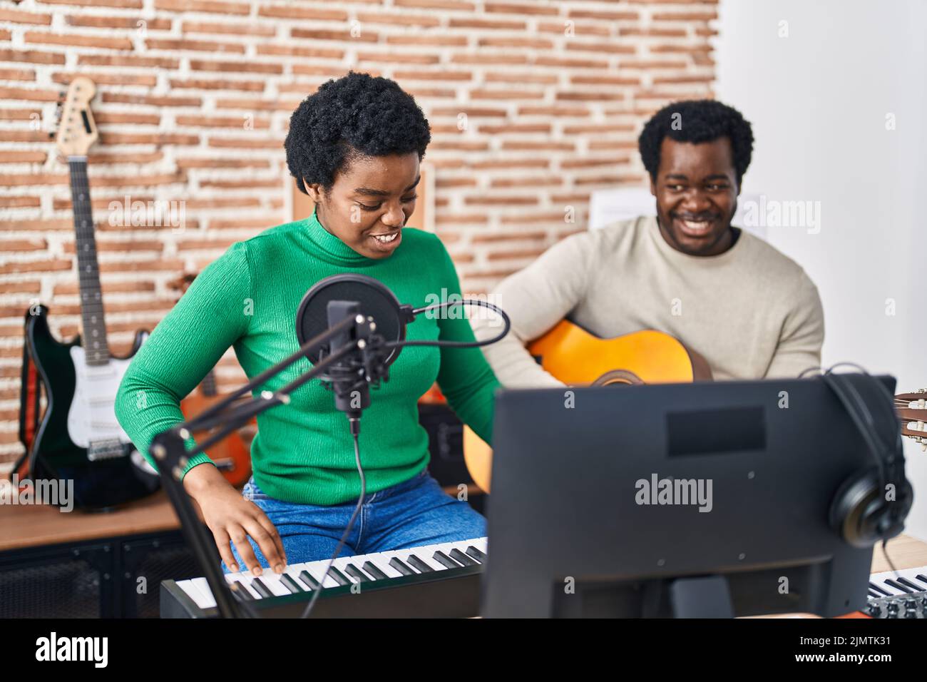 African american man and woman music group singing song playing guitar ...