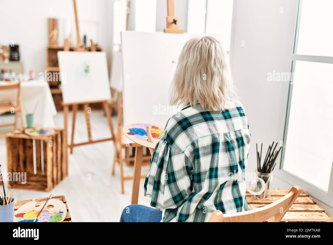 Young artist student girl on back view painting at art studio Stock ...