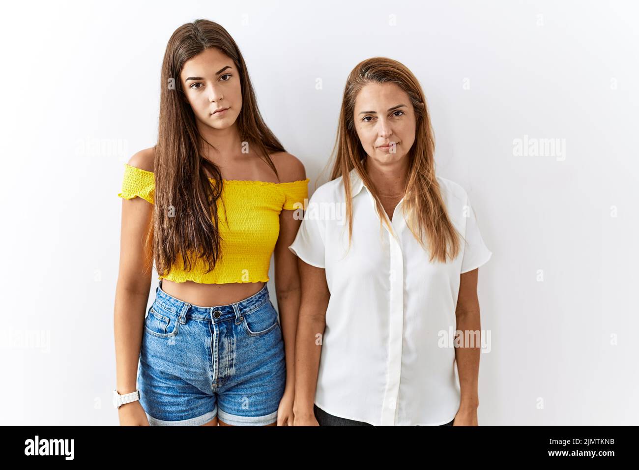 Mother And Daughter Together Standing Together Over Isolated Background