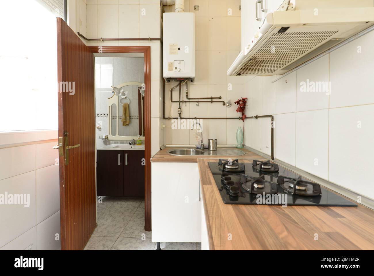 Kitchen of a small apartment with natural gas stoves, wooden ...
