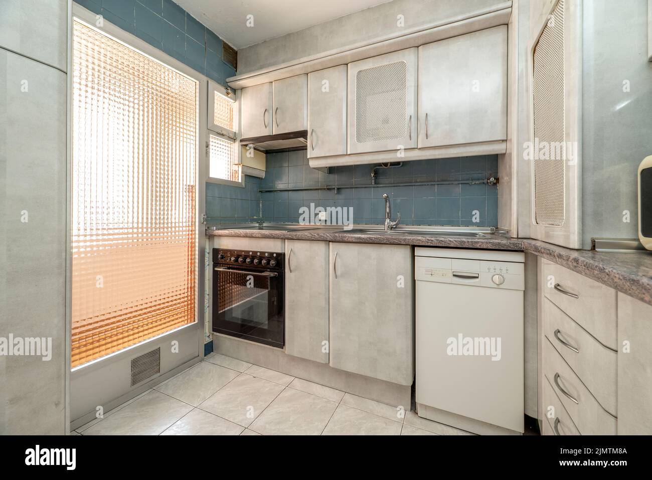 open kitchen with gray wooden cabinets, walk-in closets, cupboards ...