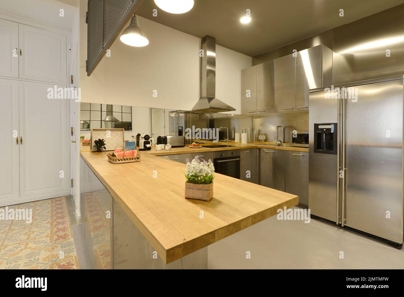 open kitchen with stainless steel cabinets wood countertops with gray ...