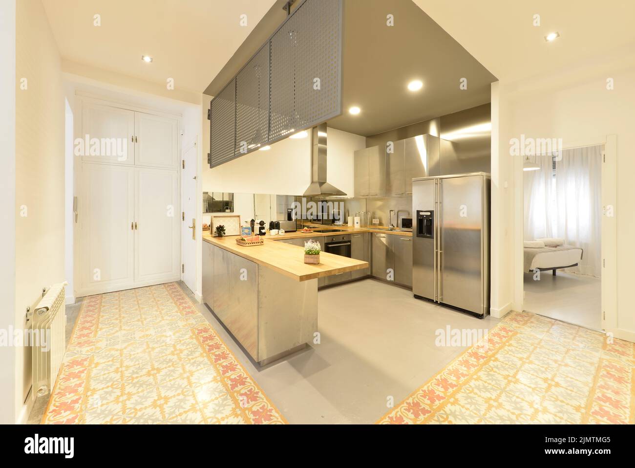 Large open kitchen with industrial style stainless steel cabinets and ...