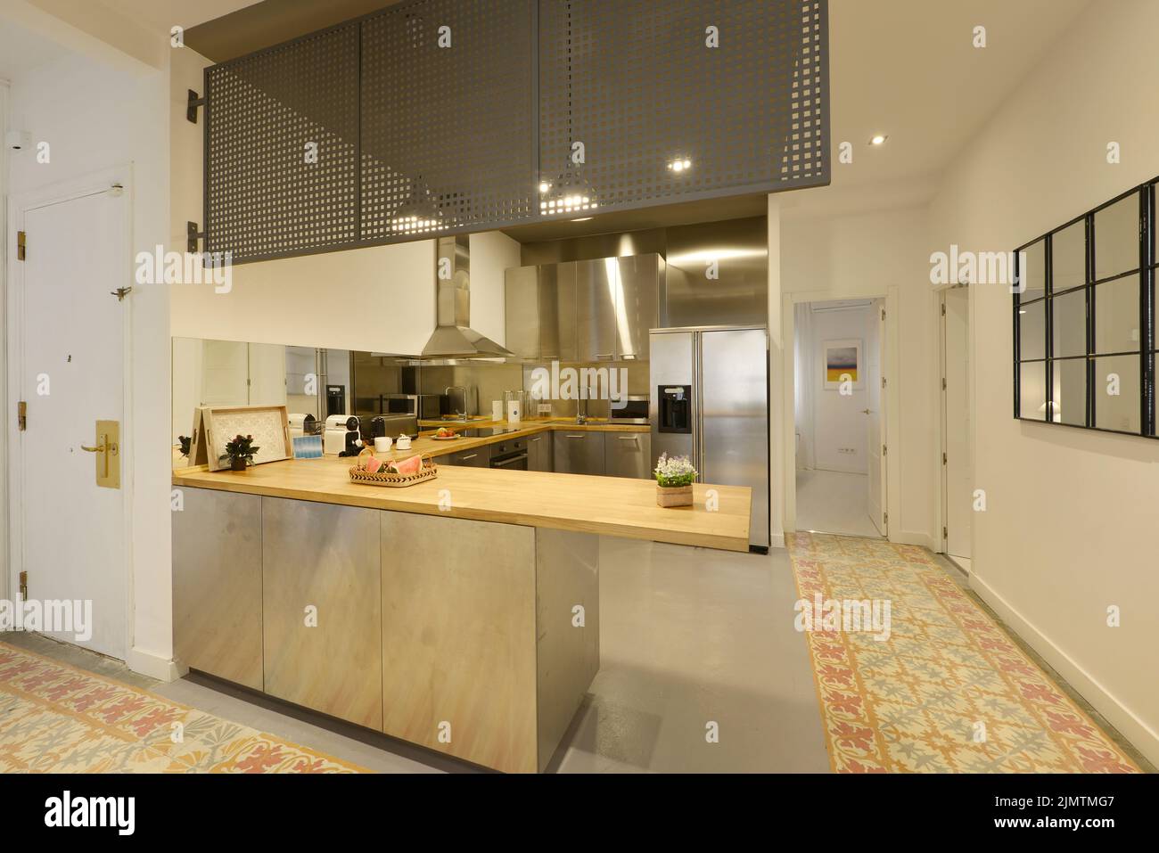 Large open kitchen with industrial style stainless steel cabinets and ...