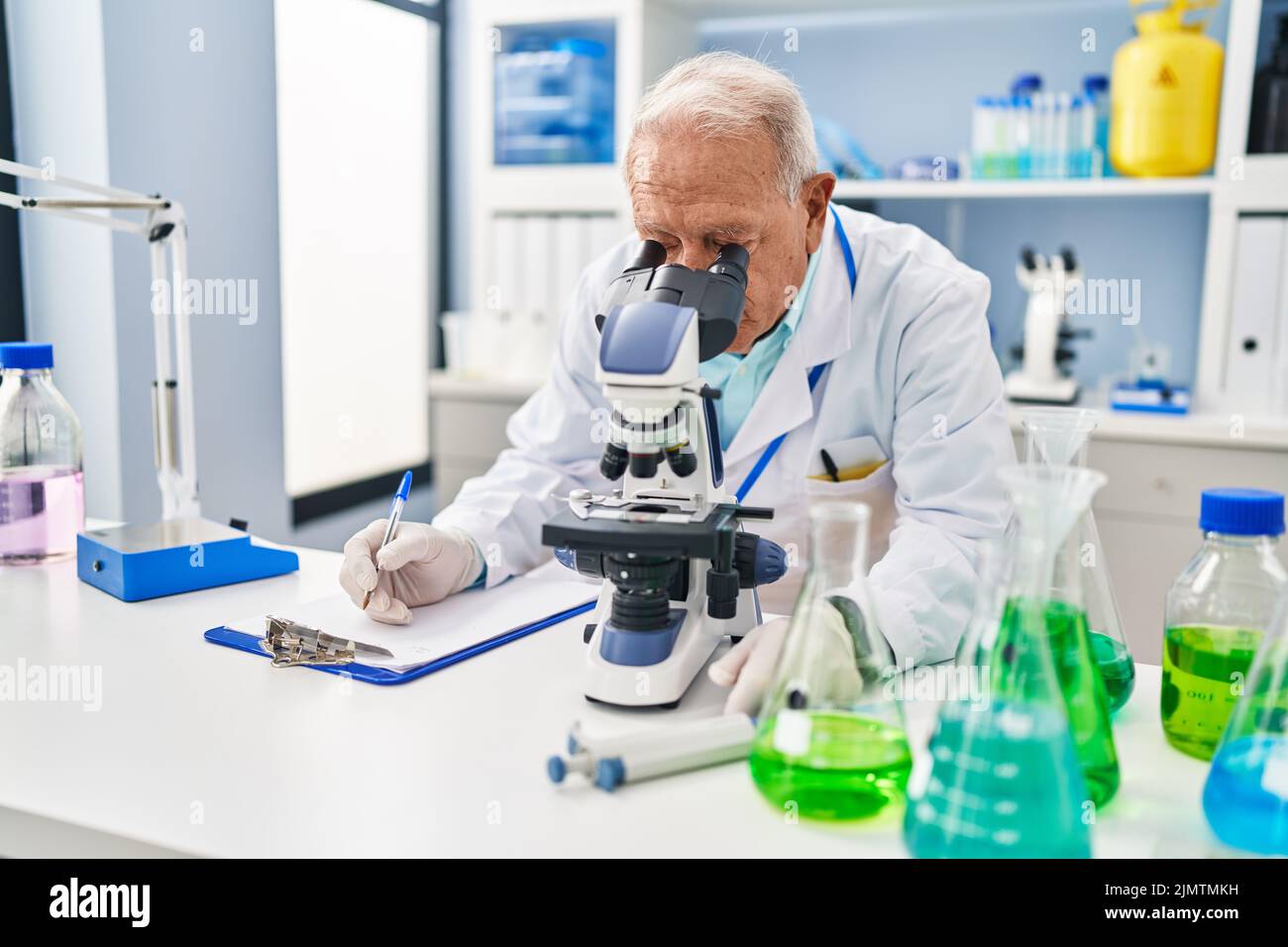 Old man scientist using microscope hi-res stock photography and images ...