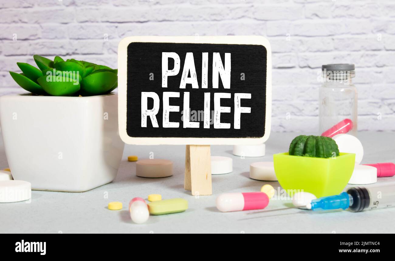 pain relief text write on blackboard, concept Stock Photo - Alamy