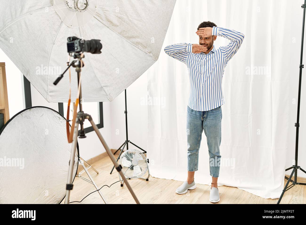 Arab young man posing as model at photography studio smiling cheerful ...