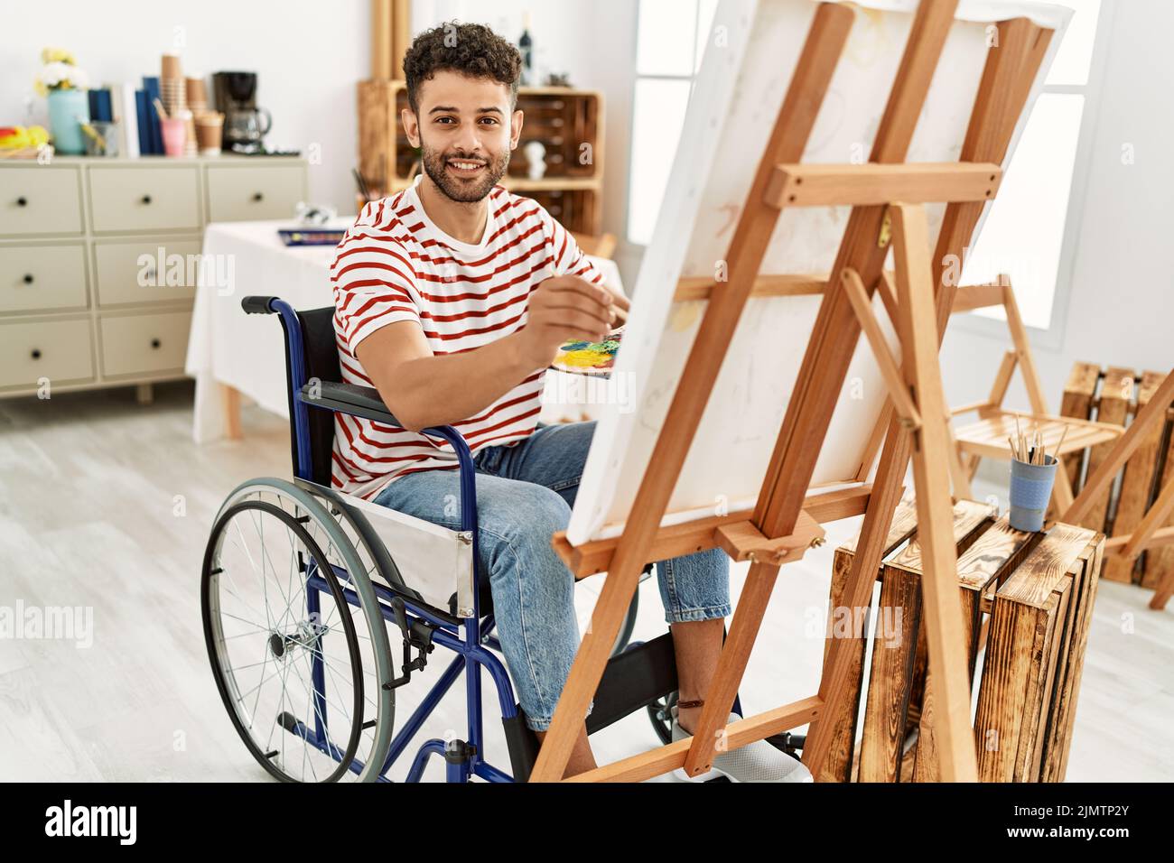 Young arab disabled artist man drawing sitting on wheelchair at art ...