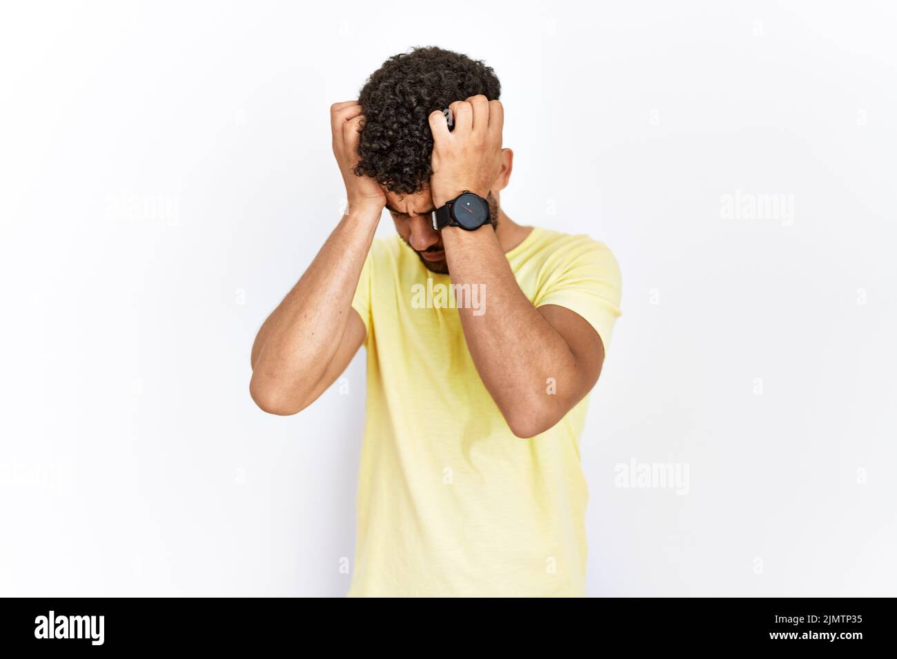 Arab young man standing over isolated background suffering from ...