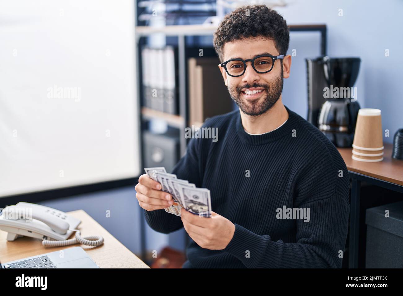 Young arab man business worker counting dollars at office Stock Photo ...