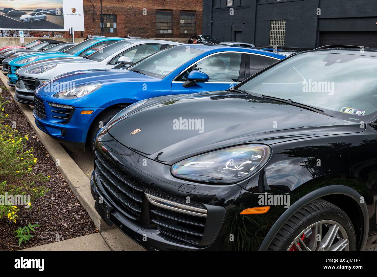 A line of various used Porsche cars at a dealership in Pittsburgh ...