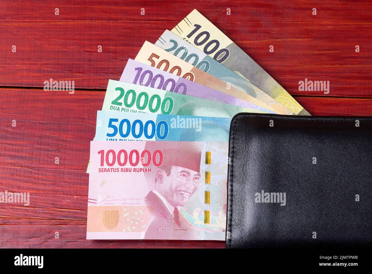 Indonesian money in the black wallet Stock Photo - Alamy