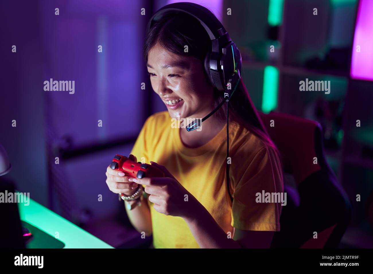 Chinese woman streamer smiling confident playing video game at gaming ...