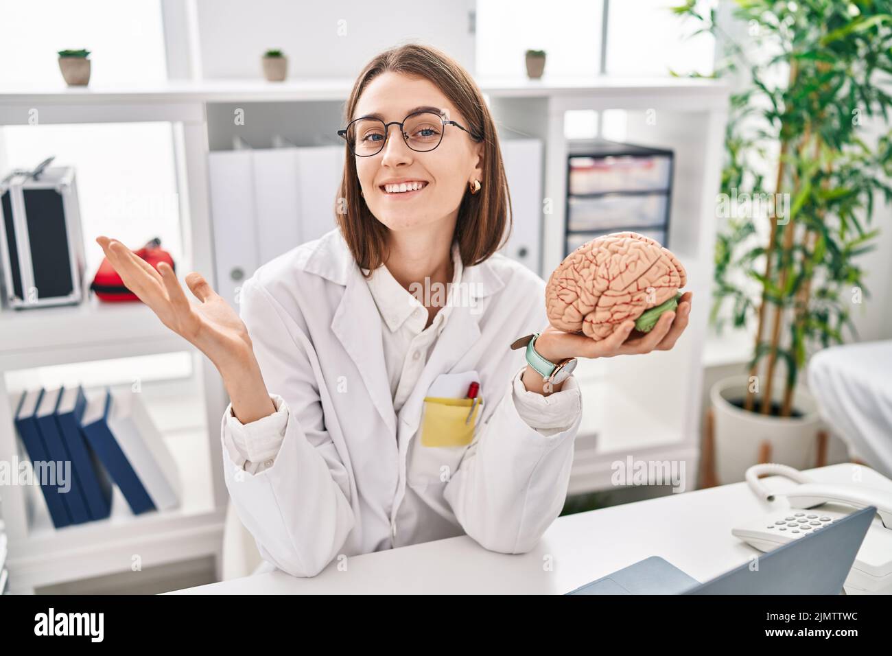 Young caucasian doctor woman holding brain as mental health concept ...