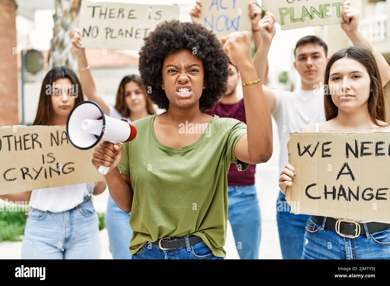 Group of young friends protesting and giving slogans at the street ...