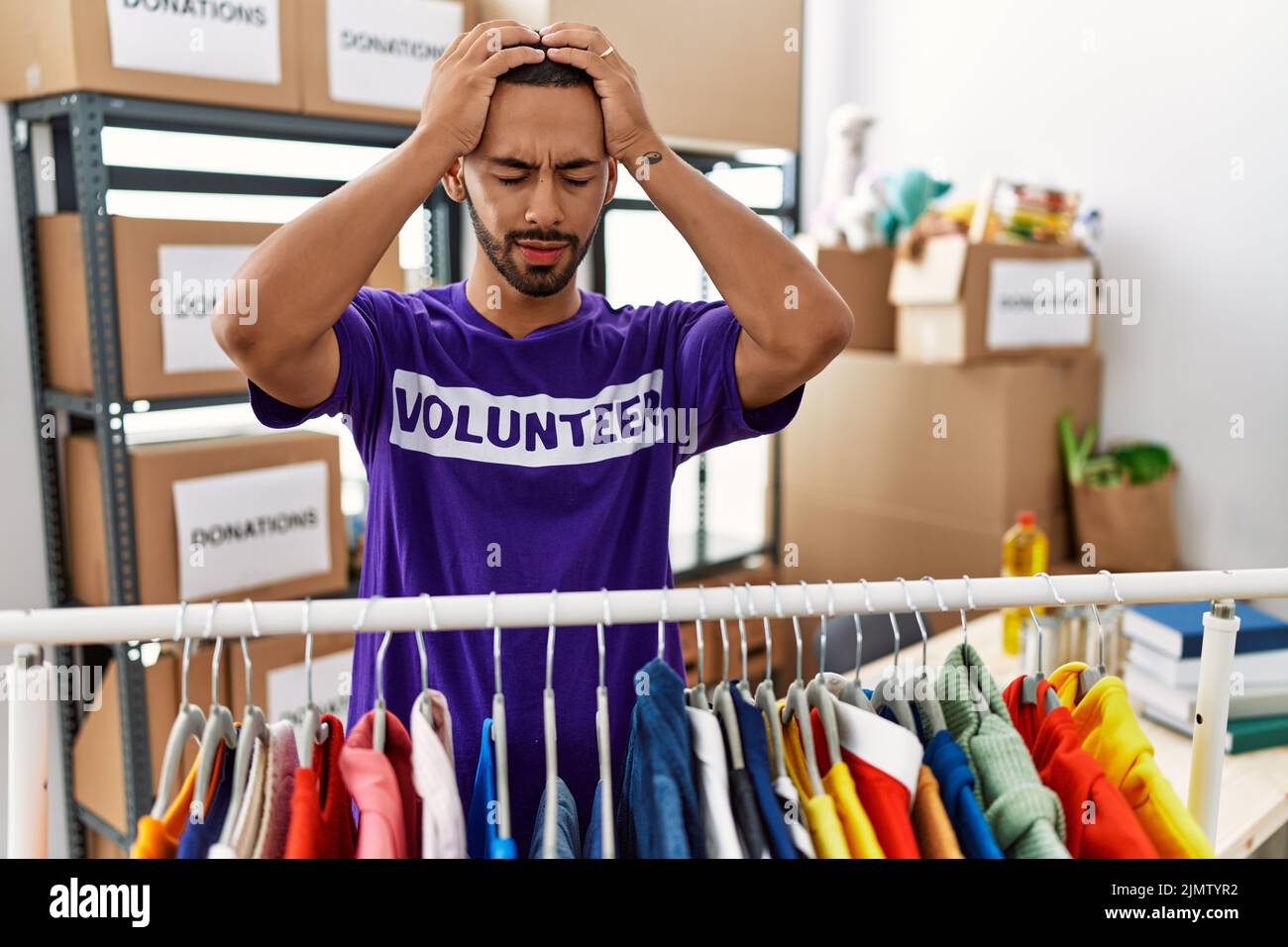 African american man wearing volunteer t shirt at donations stand ...