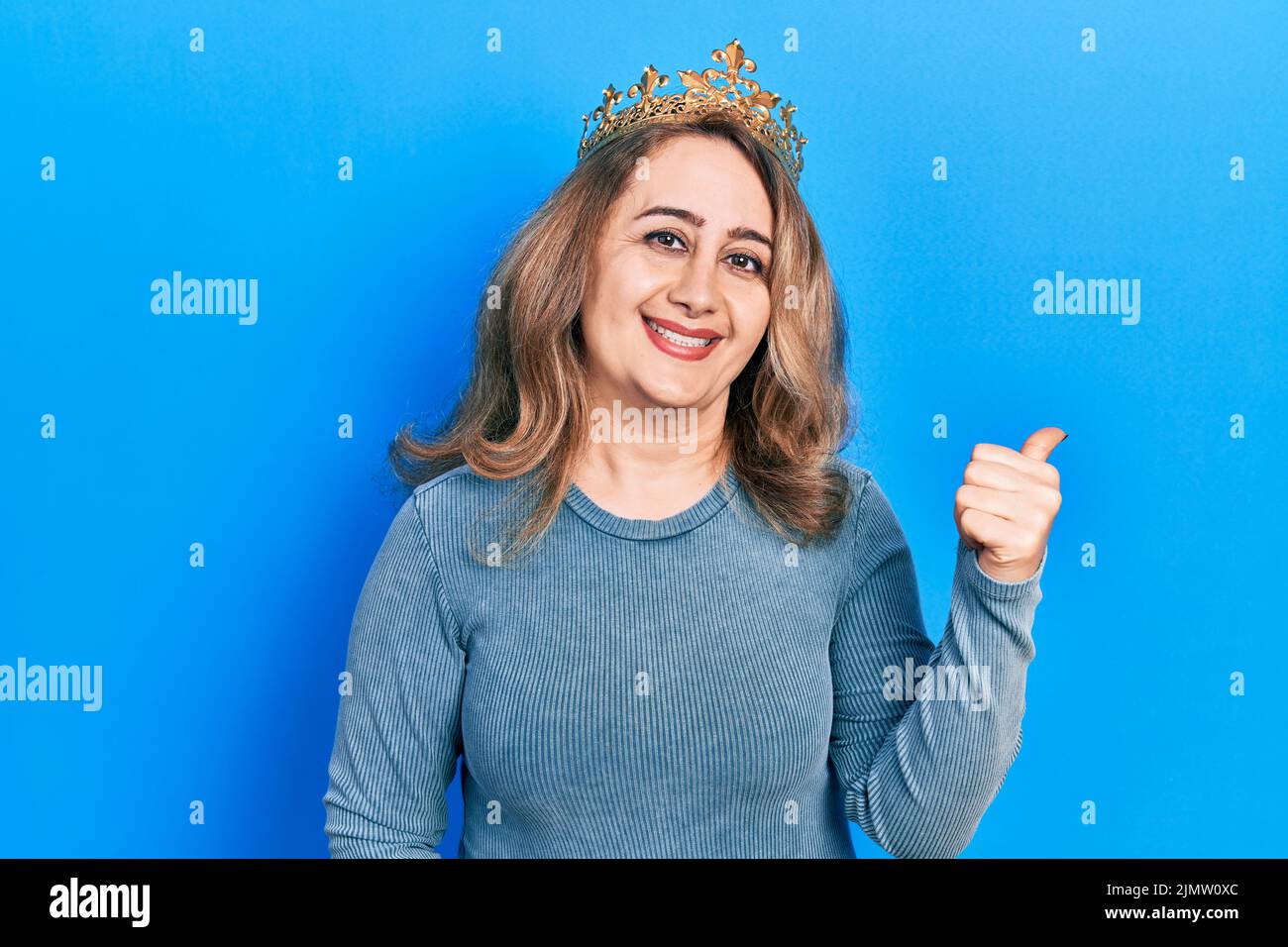 Middle age caucasian woman wearing queen crown smiling with happy face ...