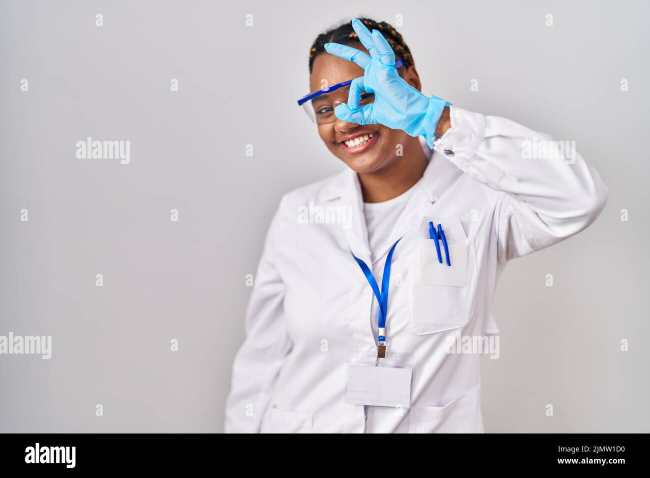 African american woman with braids wearing scientist robe smiling happy ...