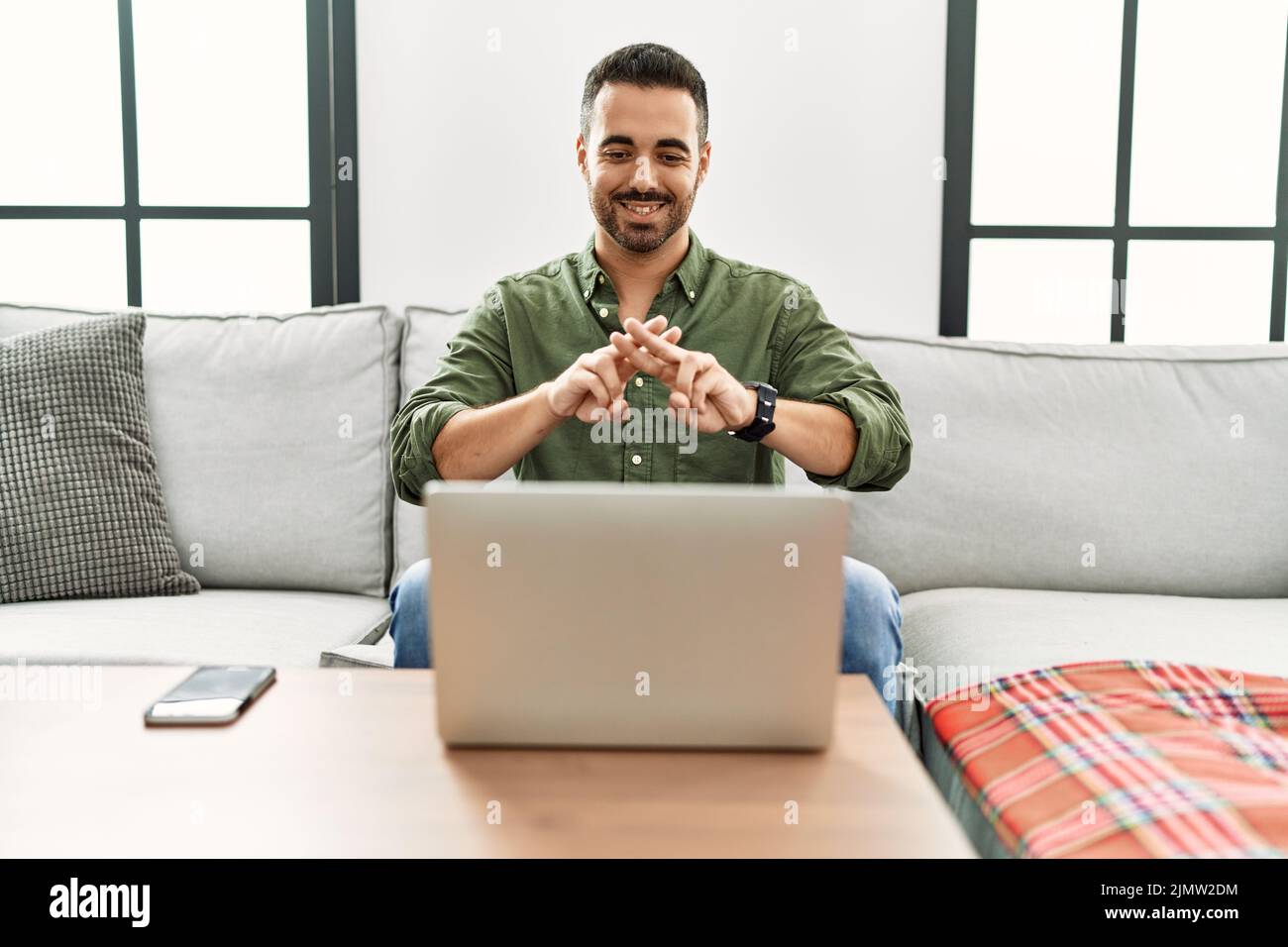Young hispanic man having video call speaking with deaf language at ...