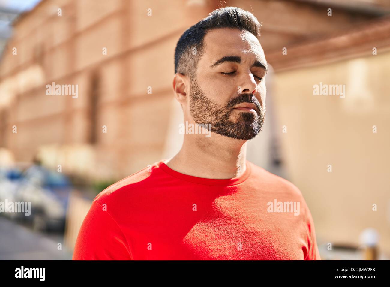 Young hispanic man smiling confident breathing at street Stock Photo ...