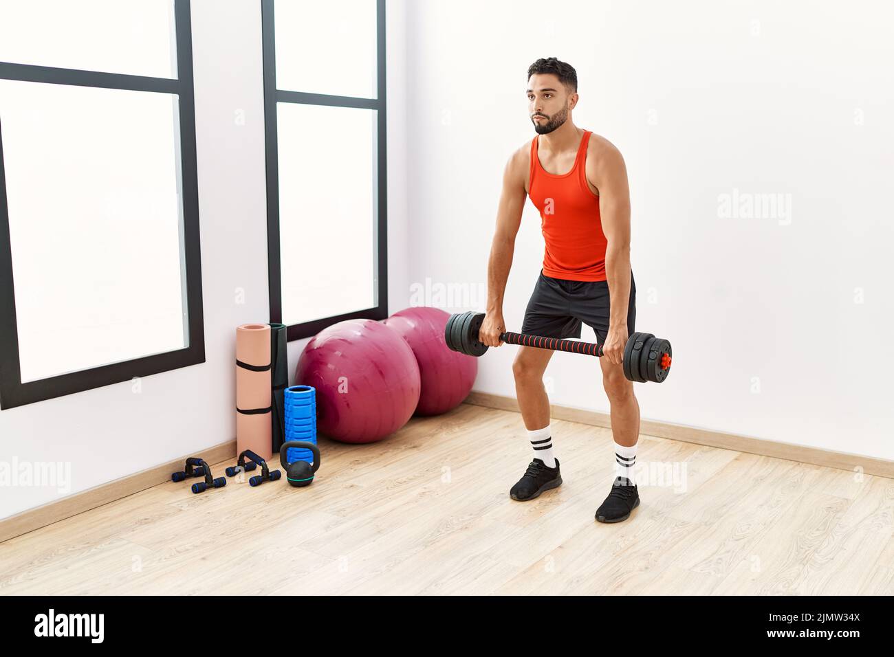 Young arab man training with dumbbells at sport center Stock Photo - Alamy