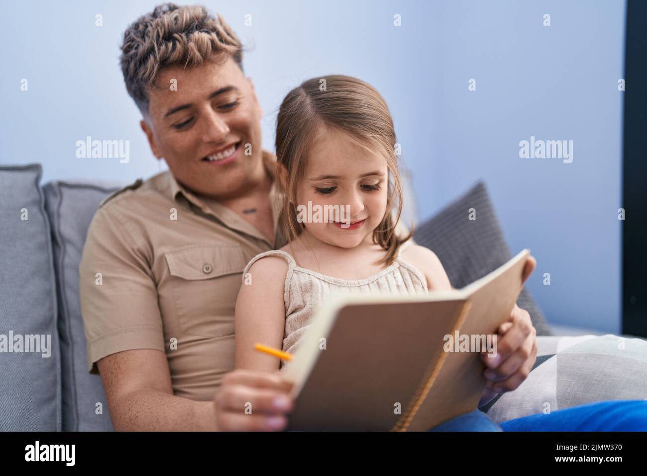 Father and daughter father and daughter writing on notebook at home ...