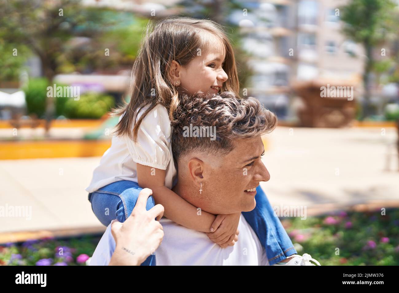 Father and daughter smiling confident hugging each other holding on back at park Stock Photo - Alamy