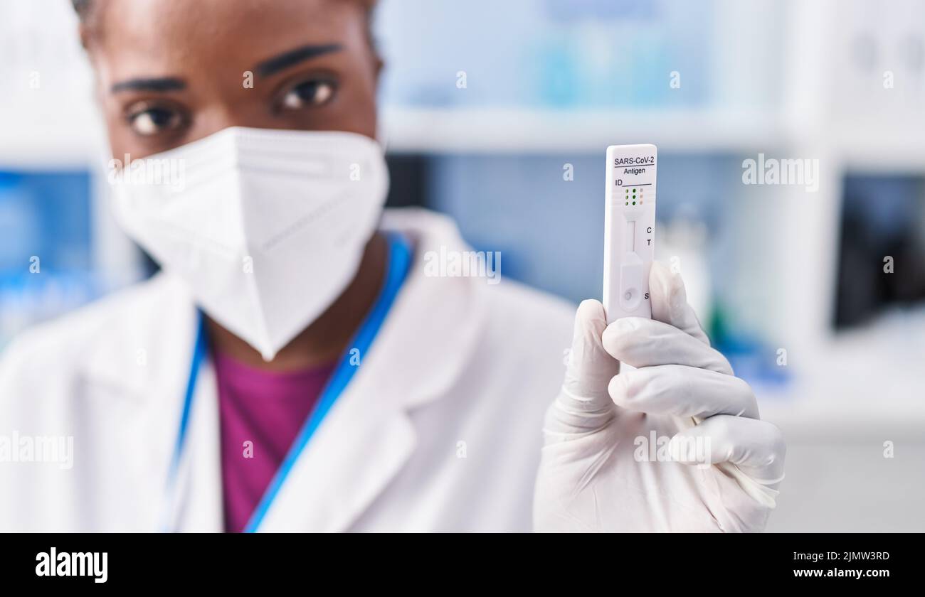 African american woman wearing scientist uniform and medical mask ...