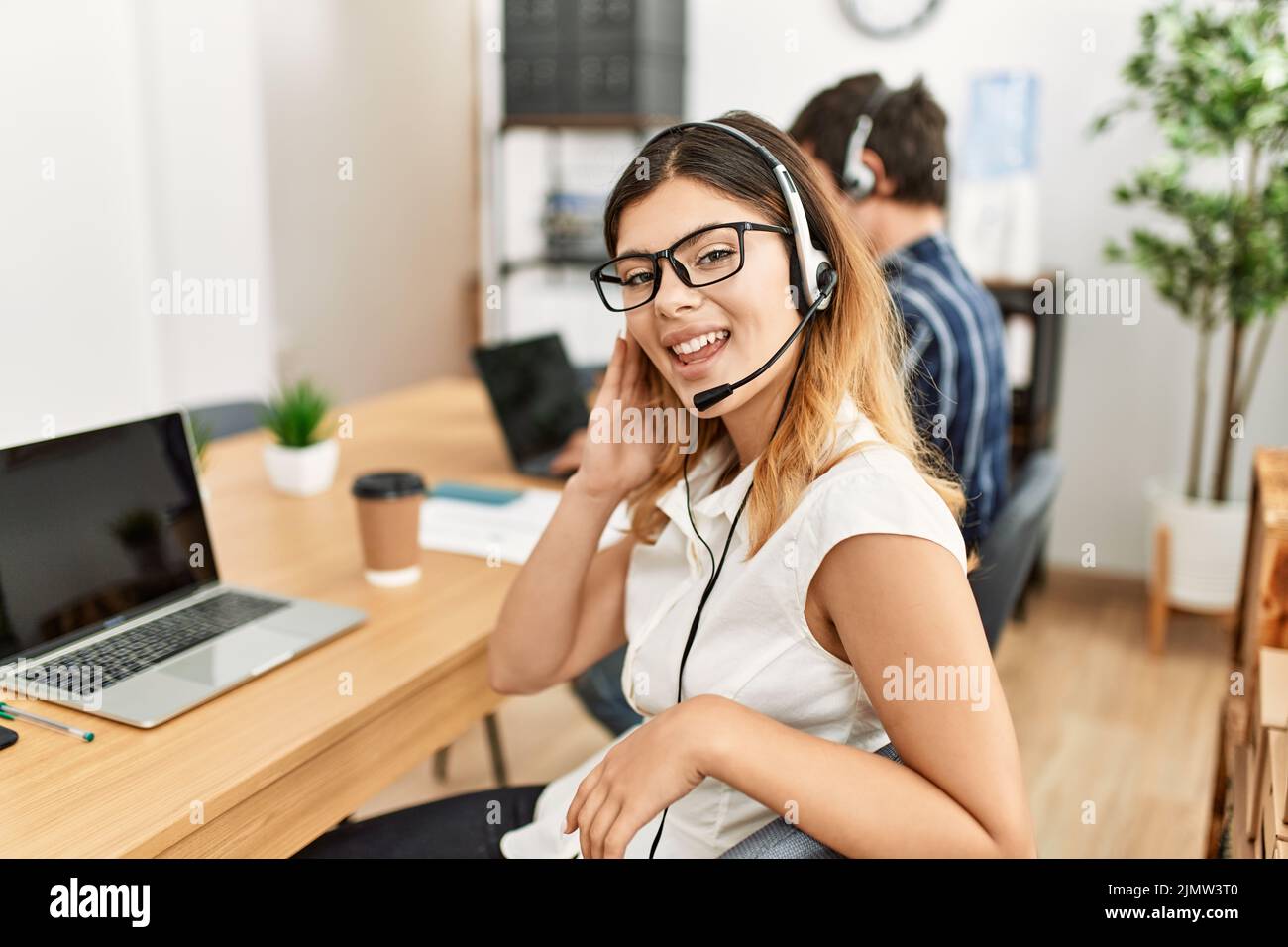 Two call center agents smiling happy working at the office Stock Photo ...
