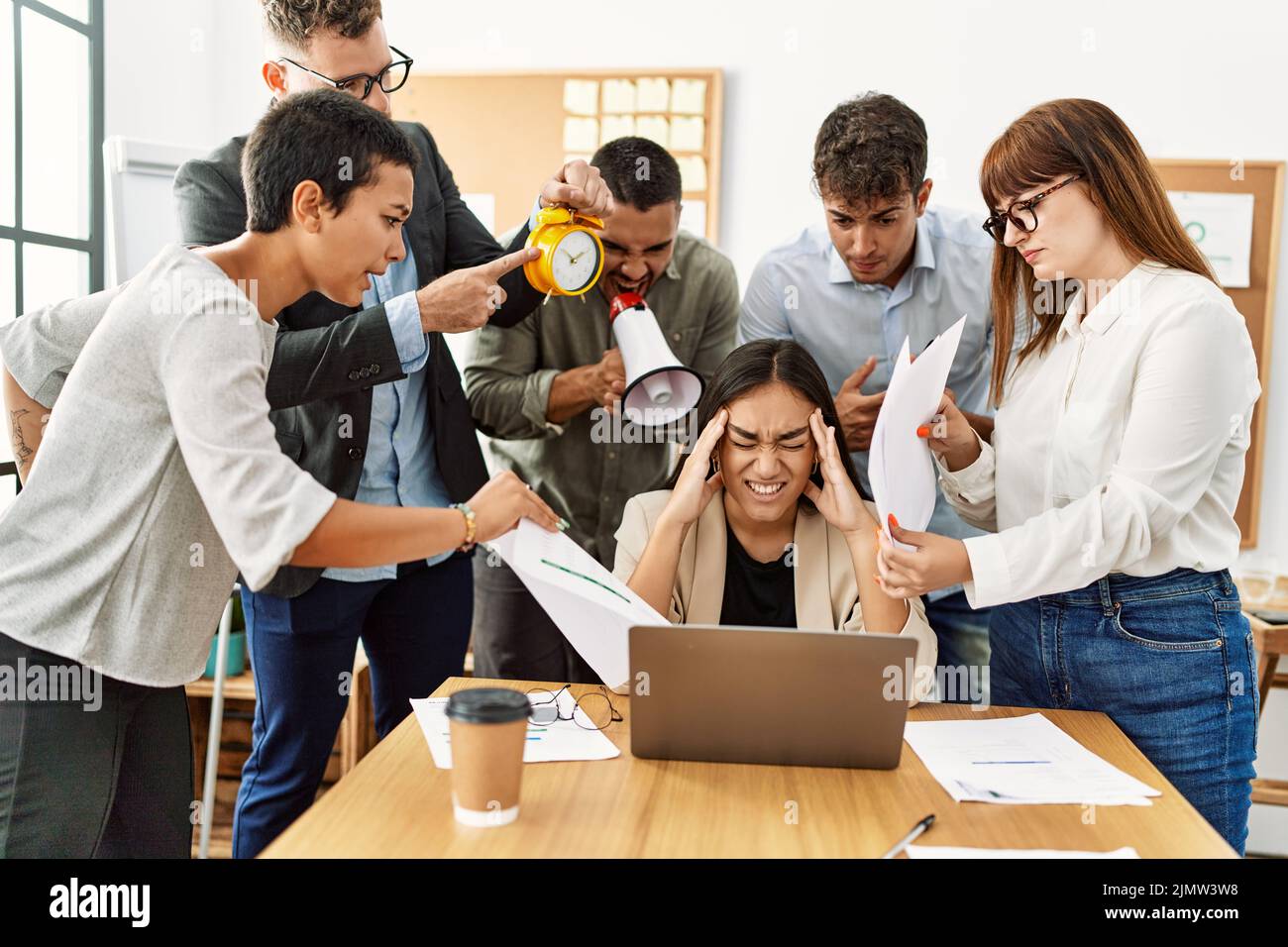 Group of business workers screaming to stressed partner at the office ...