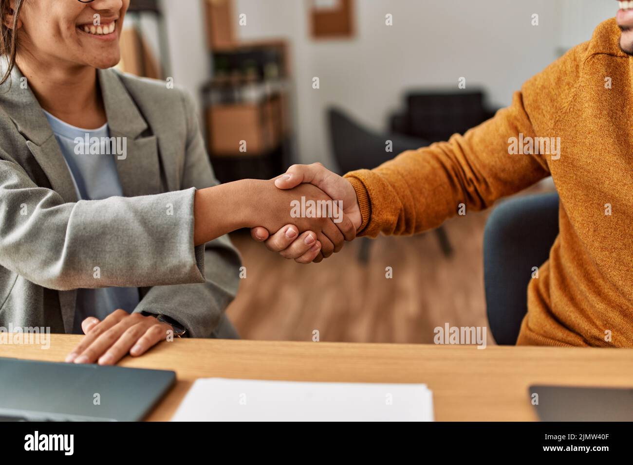 Two business workers shaking hands at the office Stock Photo - Alamy