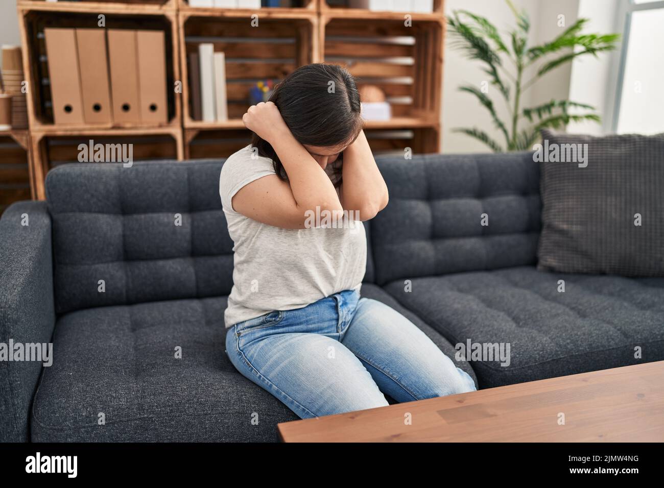 Down syndrome woman patient crying having psychology session at clinic ...