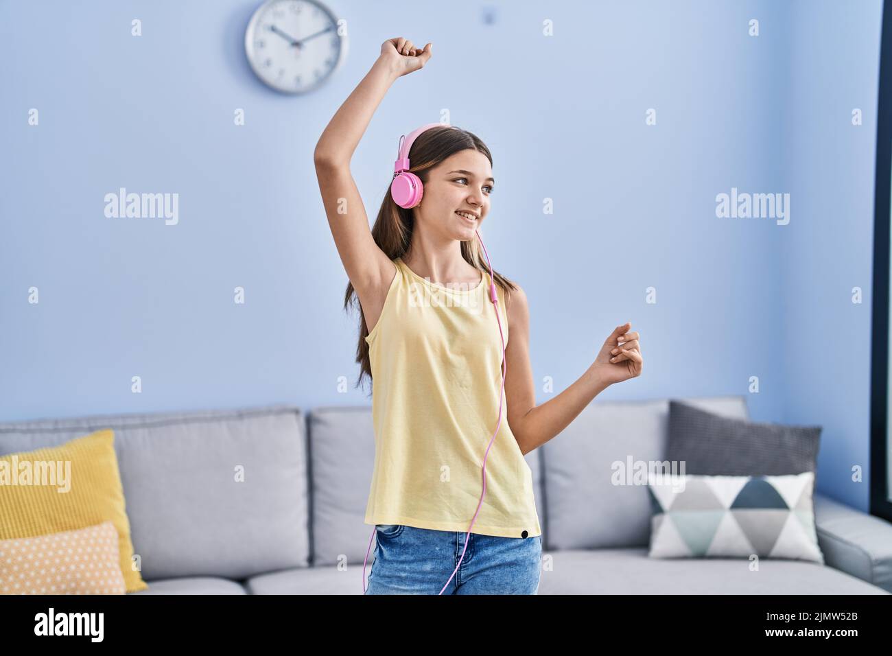 Adorable girl listening to music and dancing at home Stock Photo - Alamy