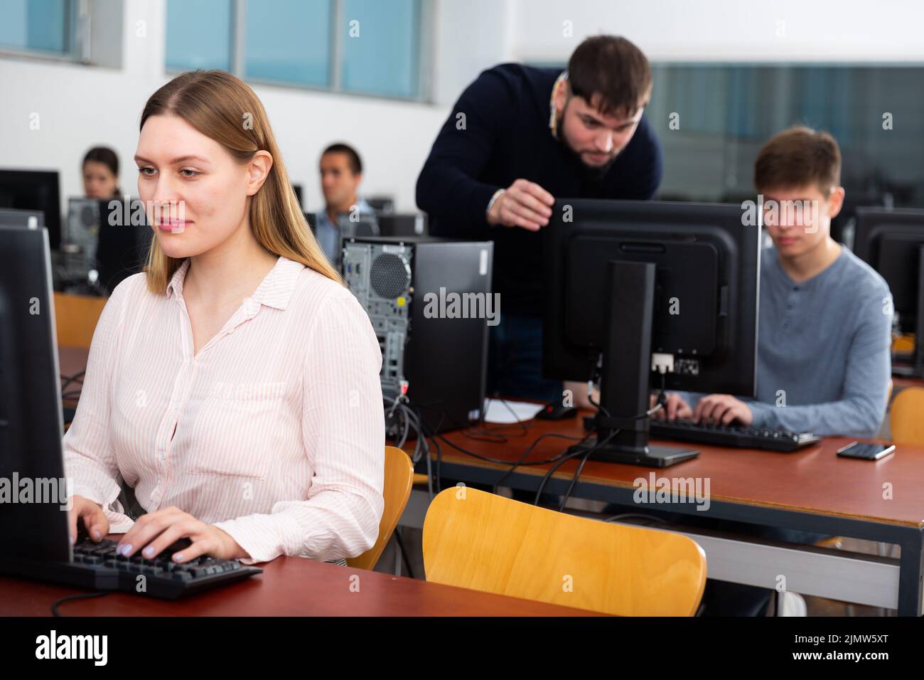 Teacher conducts computer science exam in university class Stock Photo ...