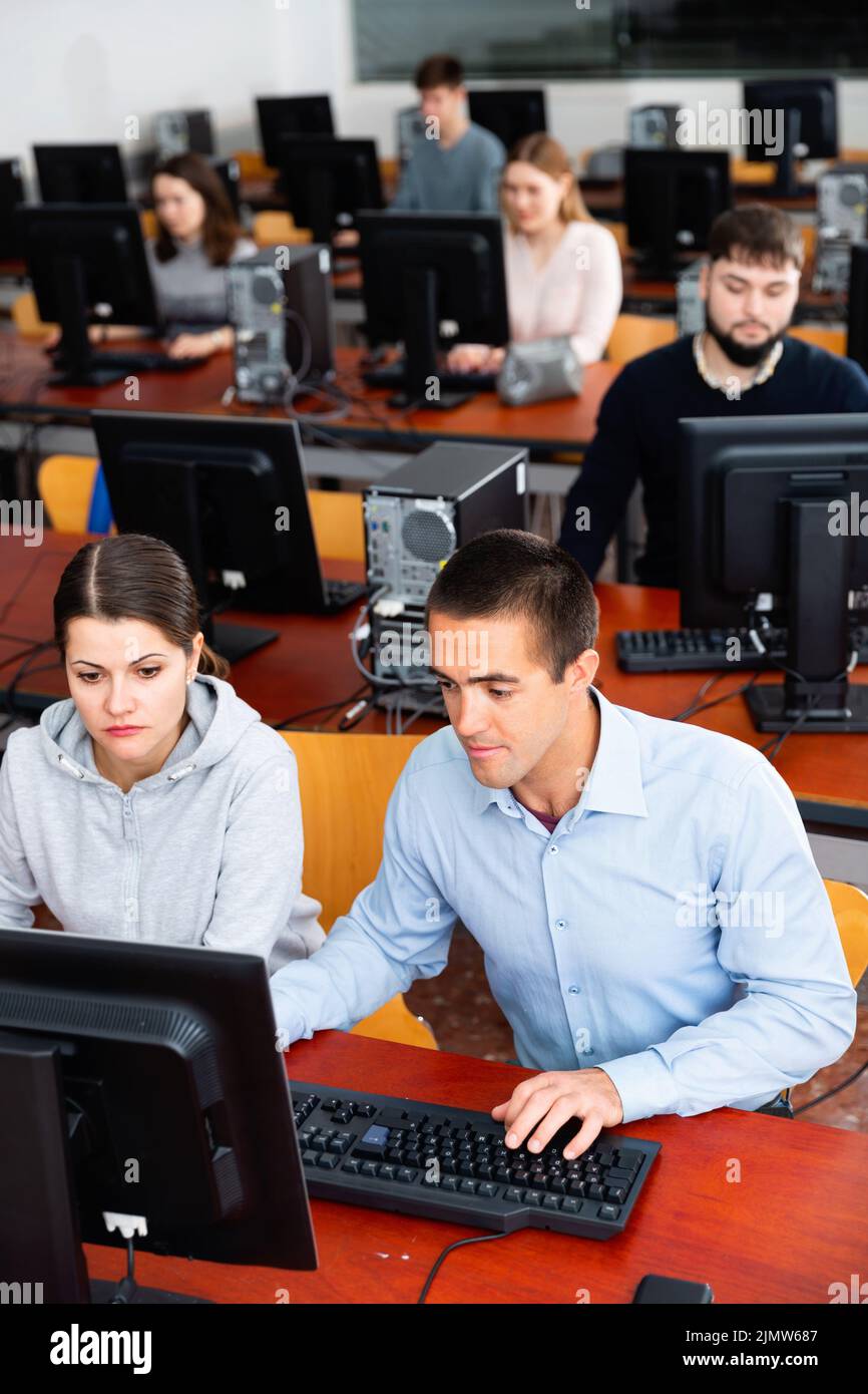 Computer Science Teacher Supervises The Execution Of A Programming Task In A Computer Class