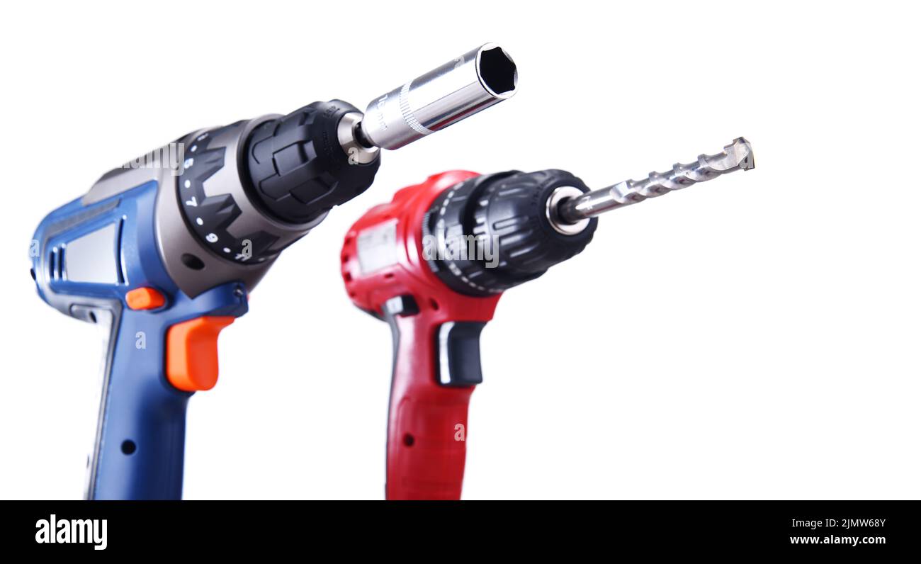 A screw gun and a pistol-grip cordless drill isolated on white ...