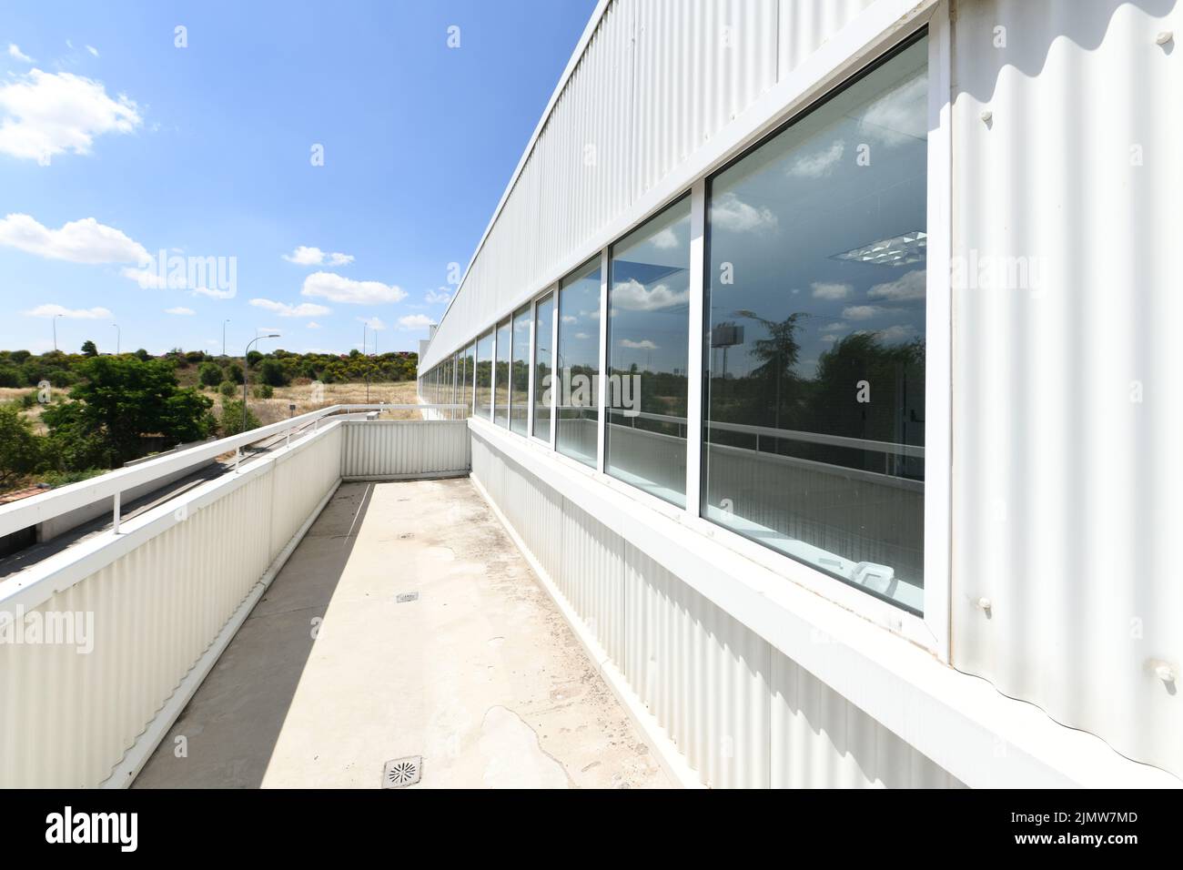 Viewpoint terrace of an industrial warehouse with a large window along ...
