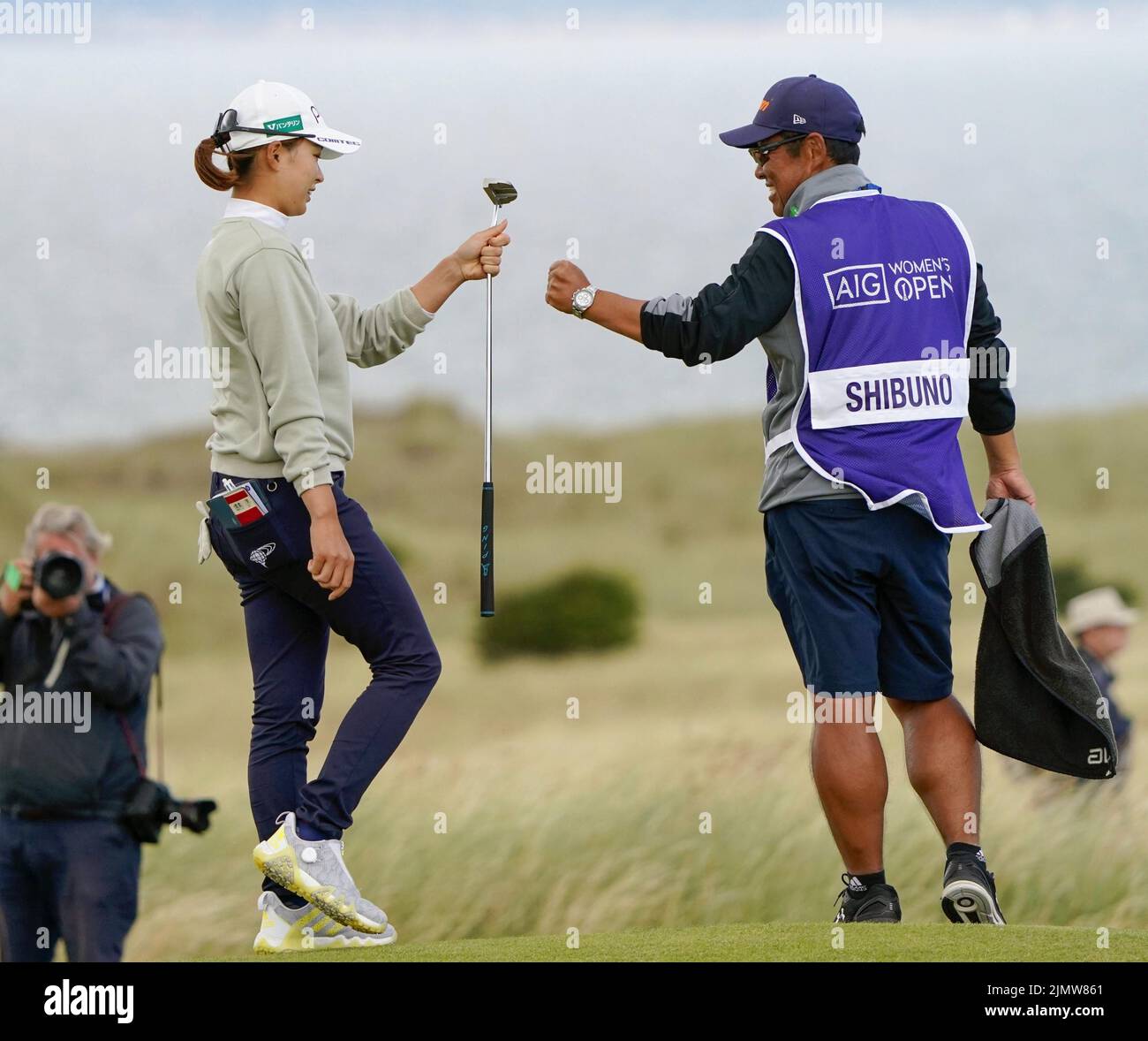 Japanese golfer Hinako Shibuno (L) bumps fists with her caddie after ...