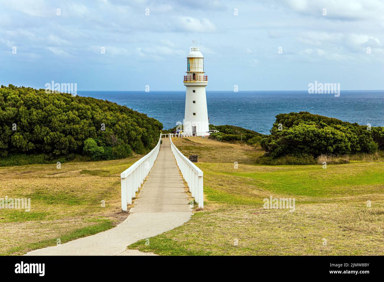 The path to the lighthouse is fenced with a railing Stock Photo - Alamy
