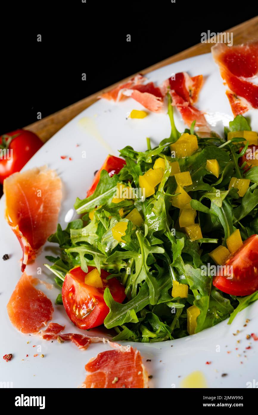 Rocket salad with dried Spanish ham Stock Photo - Alamy