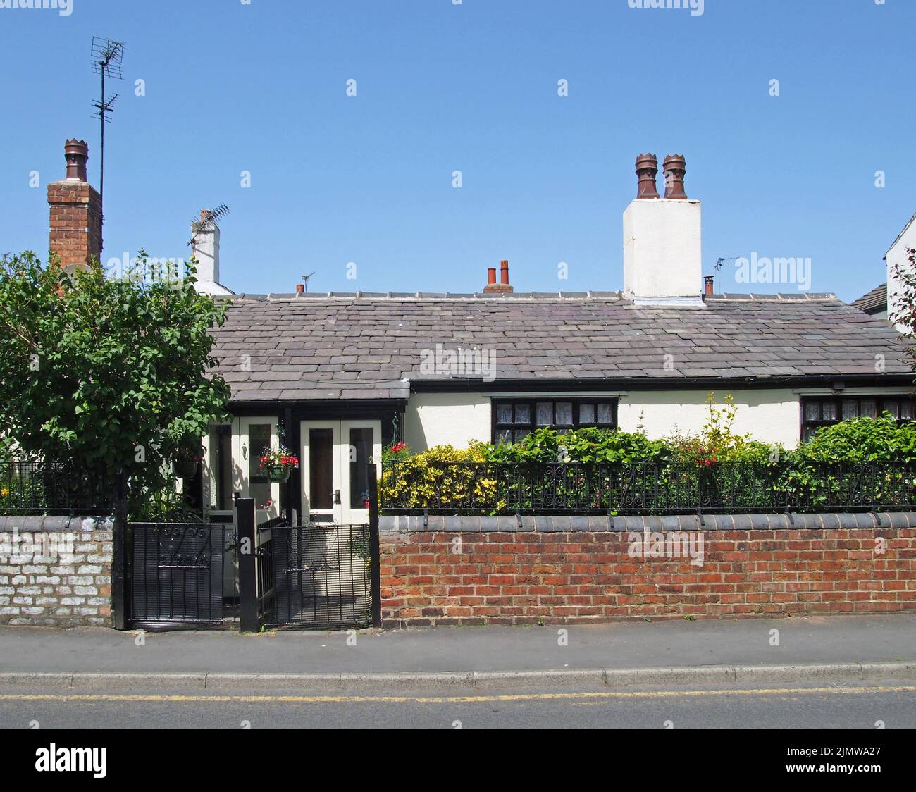 Traditional old fashioned english suburban bungalow painted white with ...