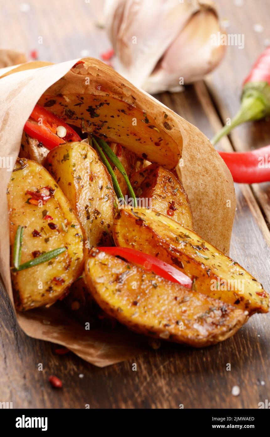 Boiled and baked potato in paper Stock Photo - Alamy