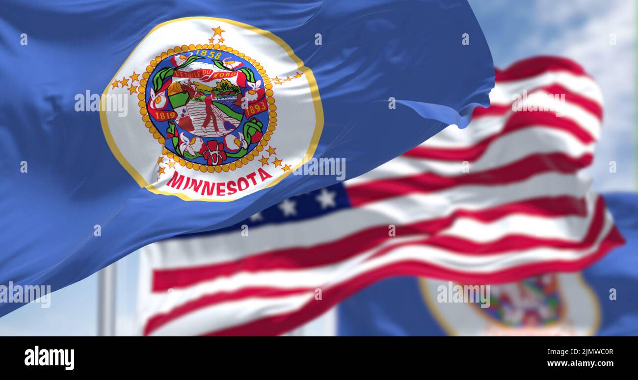 The Minnesota state flag waving along with the national flag of the ...